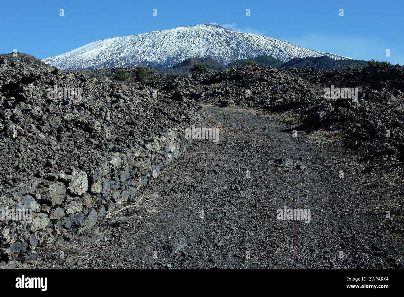 path through leaden-blue color of basalt volcano rock of Mount Etna in ...