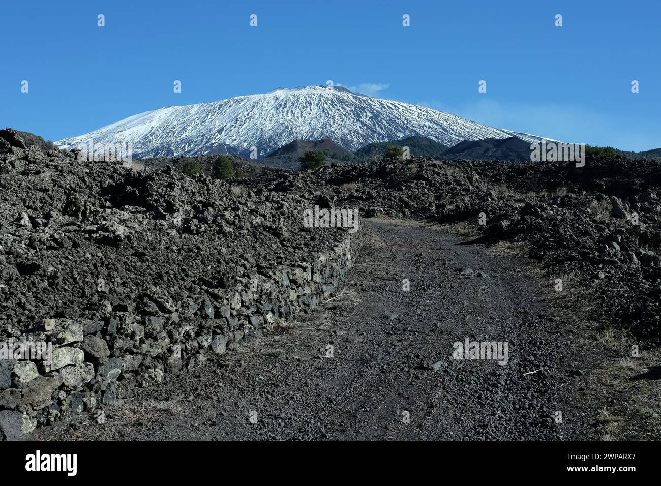 path through leaden-blue color of basalt volcano rock of Mount Etna in ...