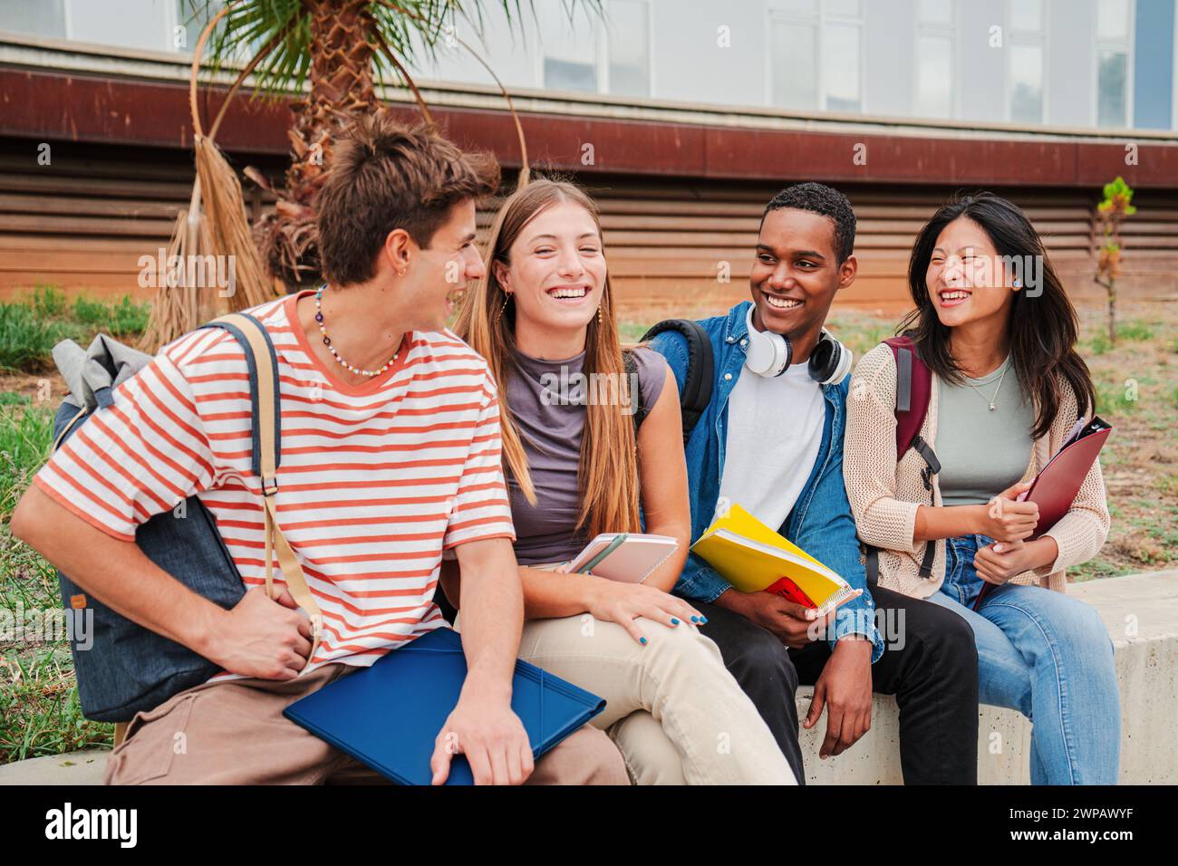 Group of multiracial young academic students talking together sitting ...