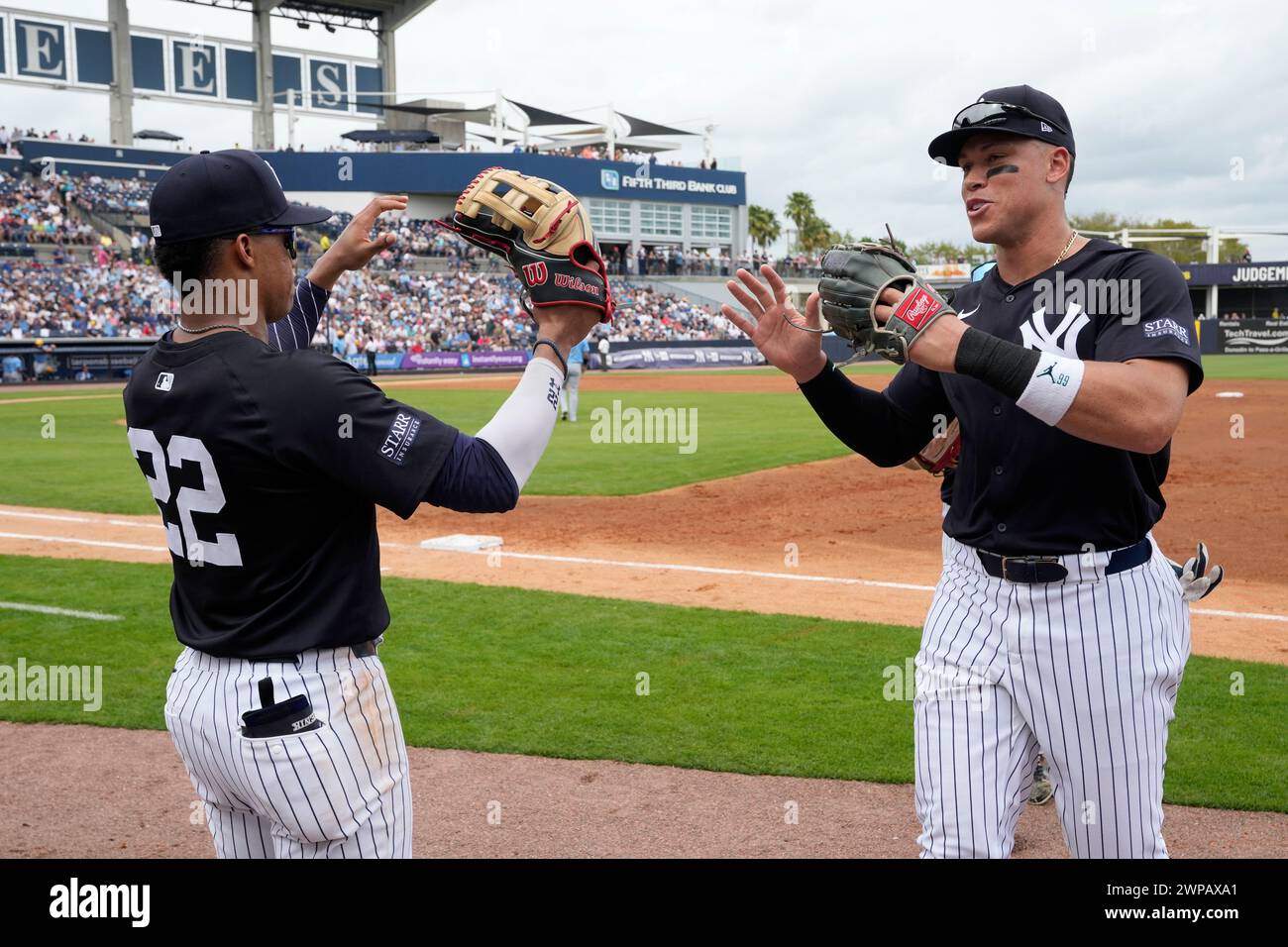 New York Yankees' Juan Soto, left, greets teammate Aaron Judge at the dugout during the third ...