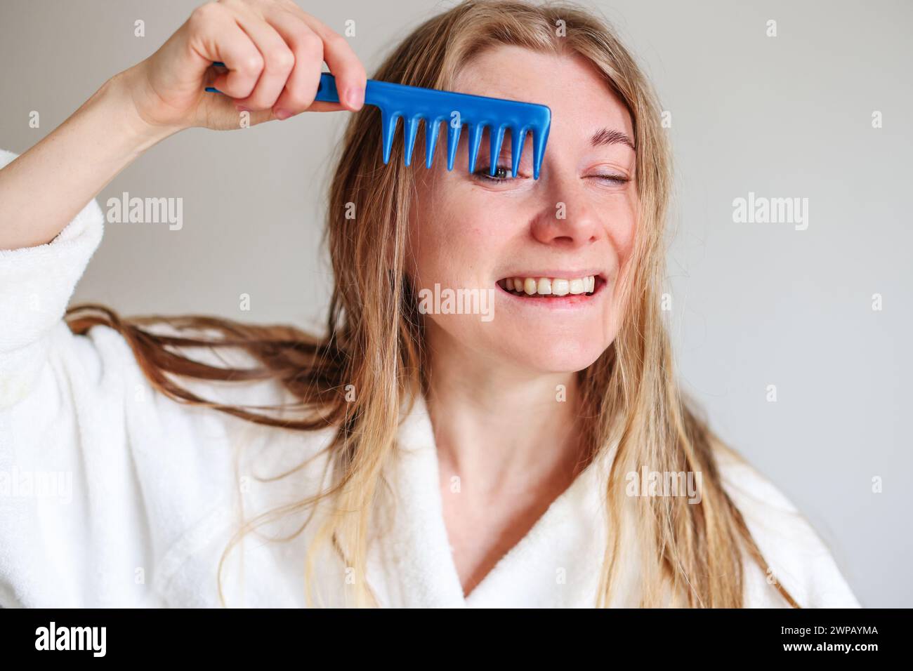 girl hiding behind a hairbrush. Haircare concept Stock Photo - Alamy