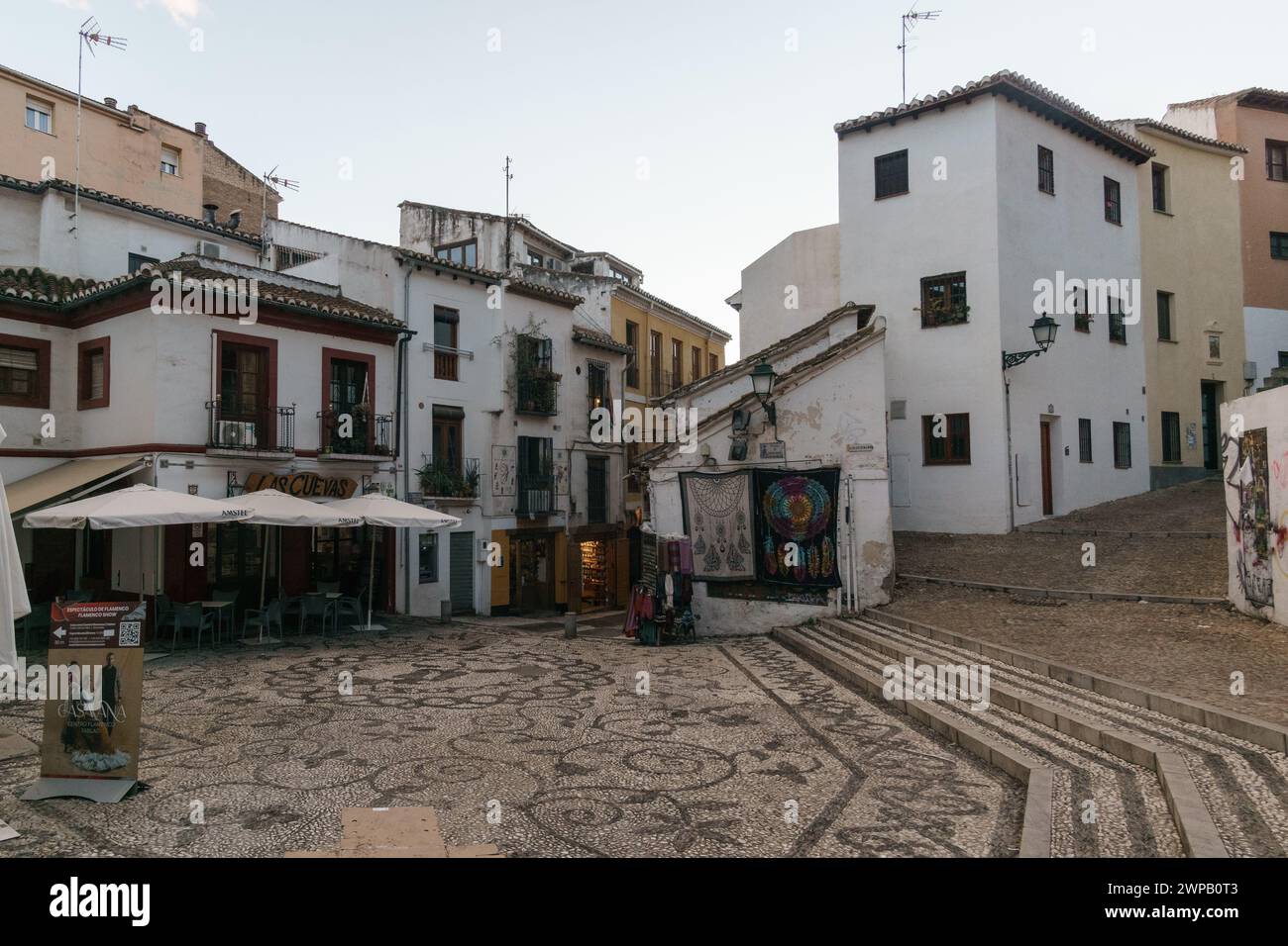 Old streets of moorish Albaicin District with restaurants and shops ...