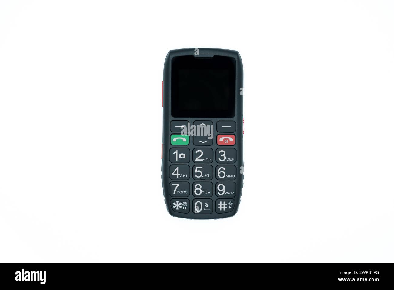 One old mobile phone with big numbers isolated on a white background ...