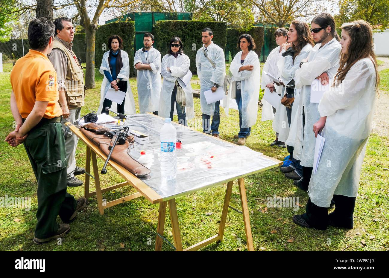 The instructor speaks to a group of veterinary students at an outdoor ...