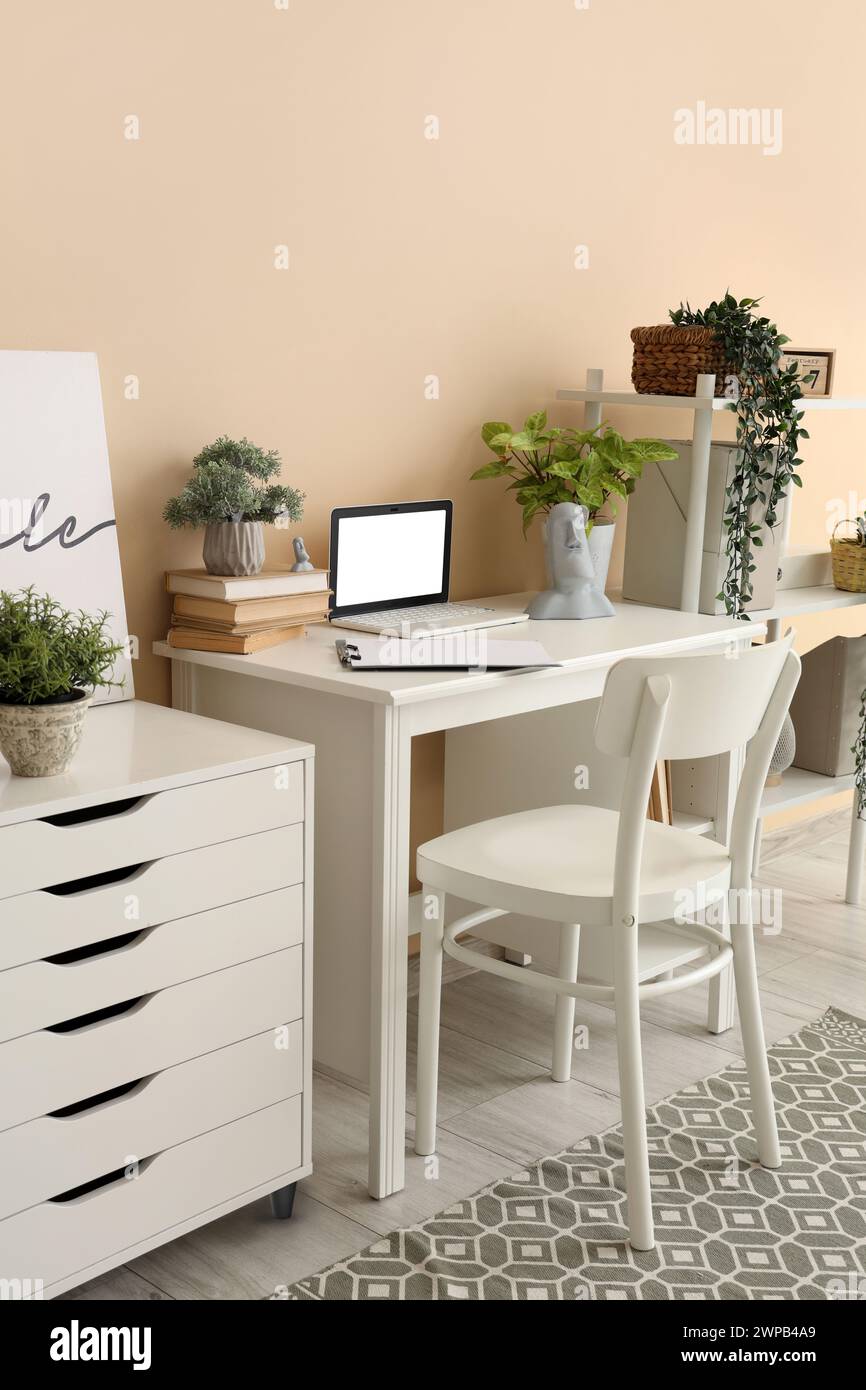 Interior of stylish office with workplace, shelf unit and drawers Stock ...