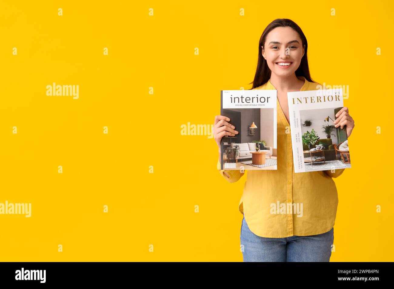 Beautiful woman with interior magazines on yellow background Stock ...