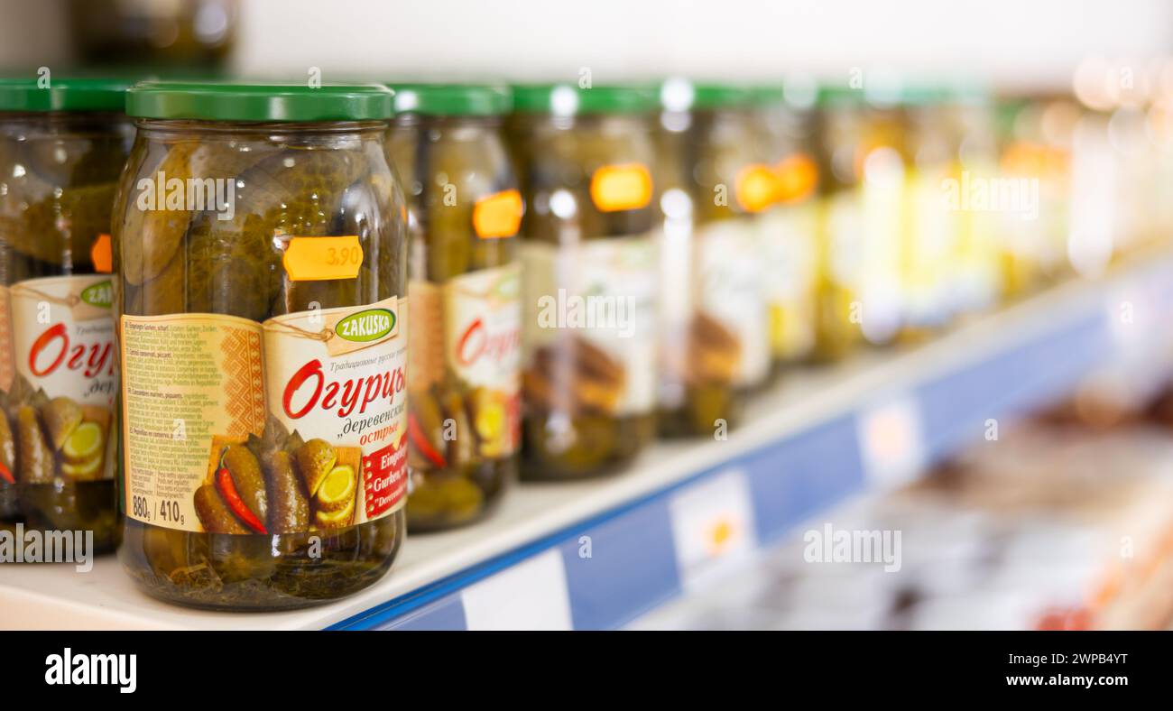 Russian goods store shelves have glass jar with canned pickled ...