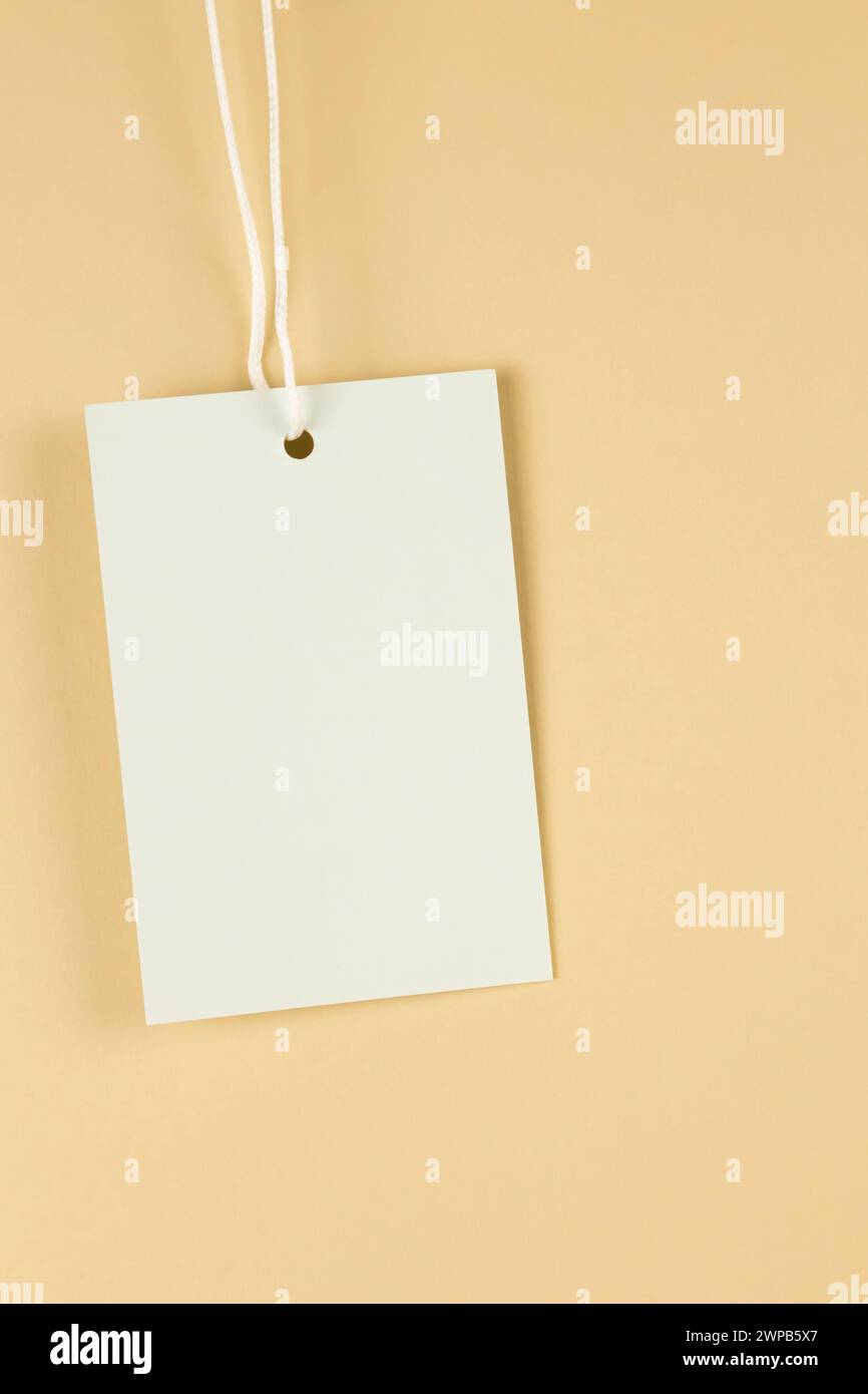 Price tag, a clean white label on a beige background. The concept of ...