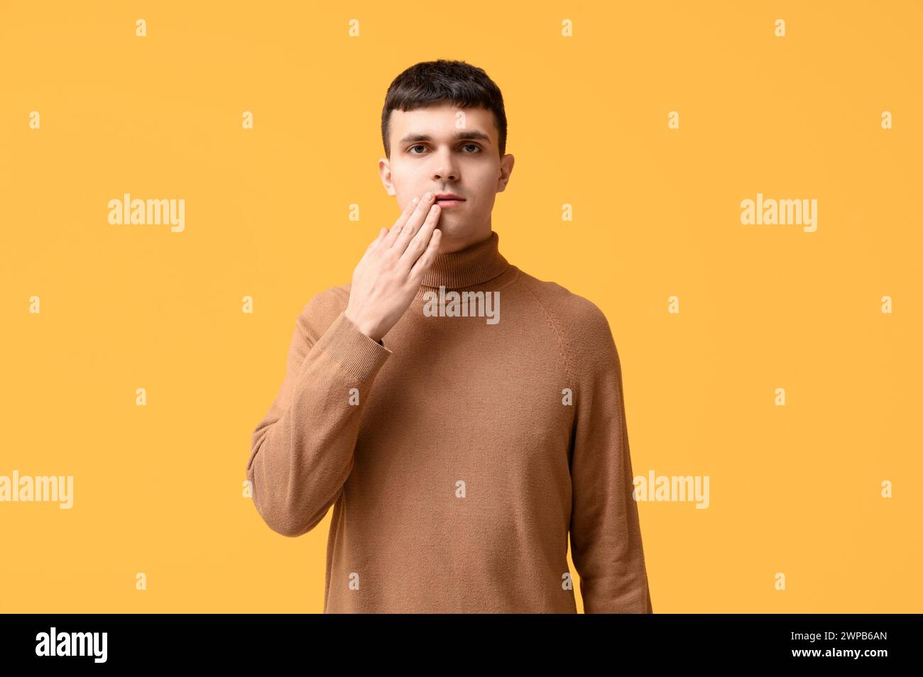 Young deaf mute man using sign language on yellow background Stock ...