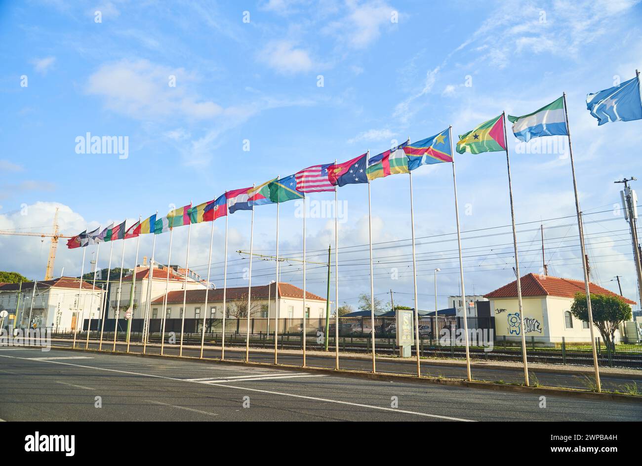 Colorful flags flutter in the sky above urban buildings Stock Photo - Alamy