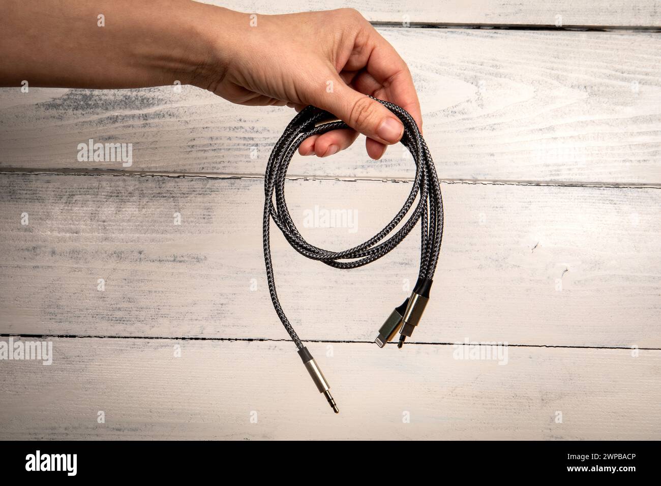 3 In 1 Type-C3.5mm Jack Aux Cable in hand. White background Stock Photo ...