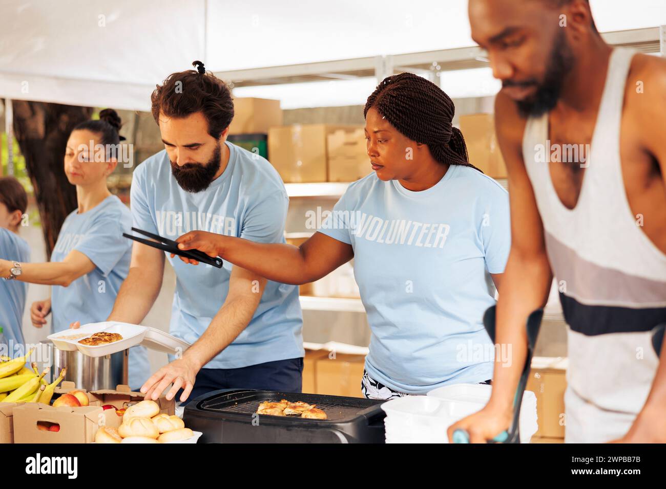 African american woman helping disabled man cook hi-res stock ...