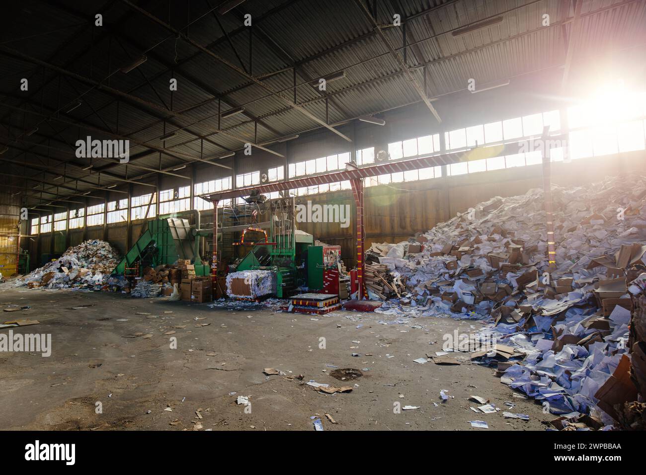 Pressing and packing of wastepaper in recycling factory Stock Photo - Alamy