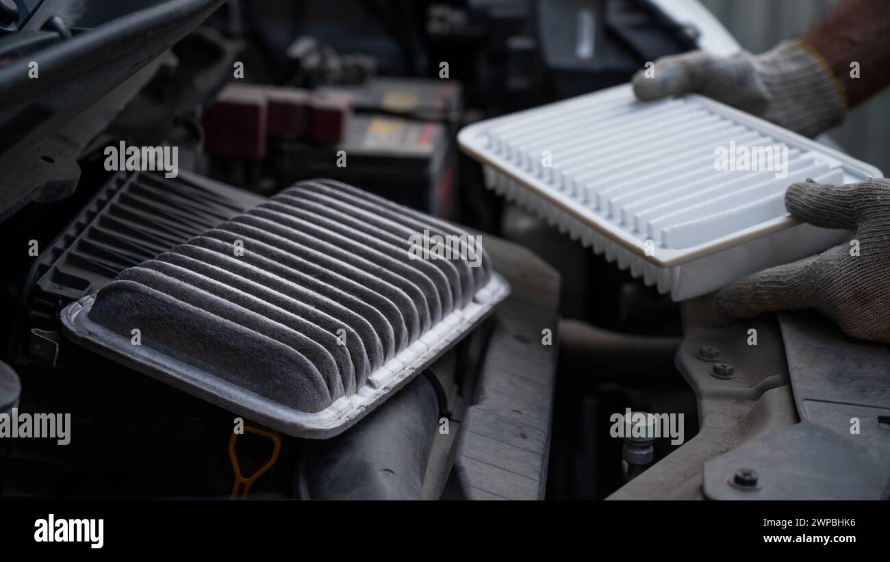 The master changes the air filter in the car engine Stock Photo - Alamy