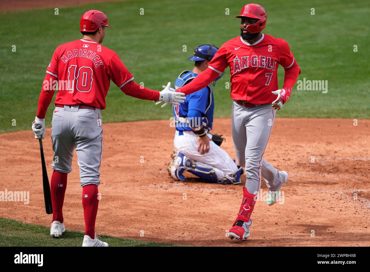 Los Angeles Angels' Jo Adell (7) greets Jake Marisnick after hitting a ...