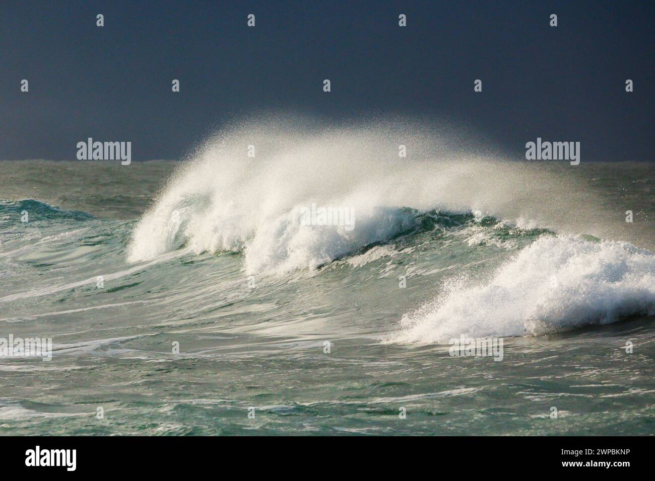 large wave breaks in the open sea off the coast of Brittany, France ...