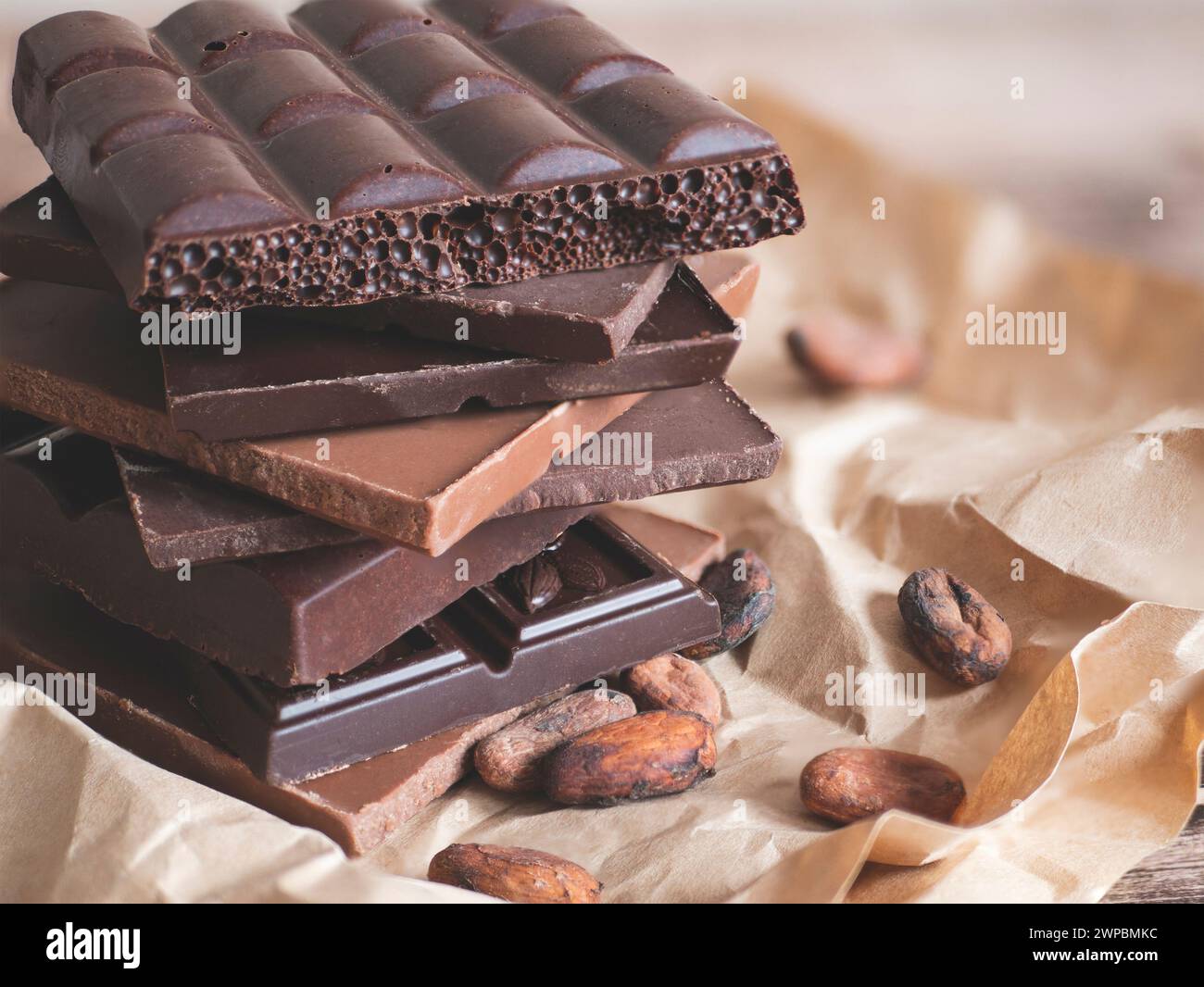 Big stack of chocolate bars different types and cocoa beans, selective ...