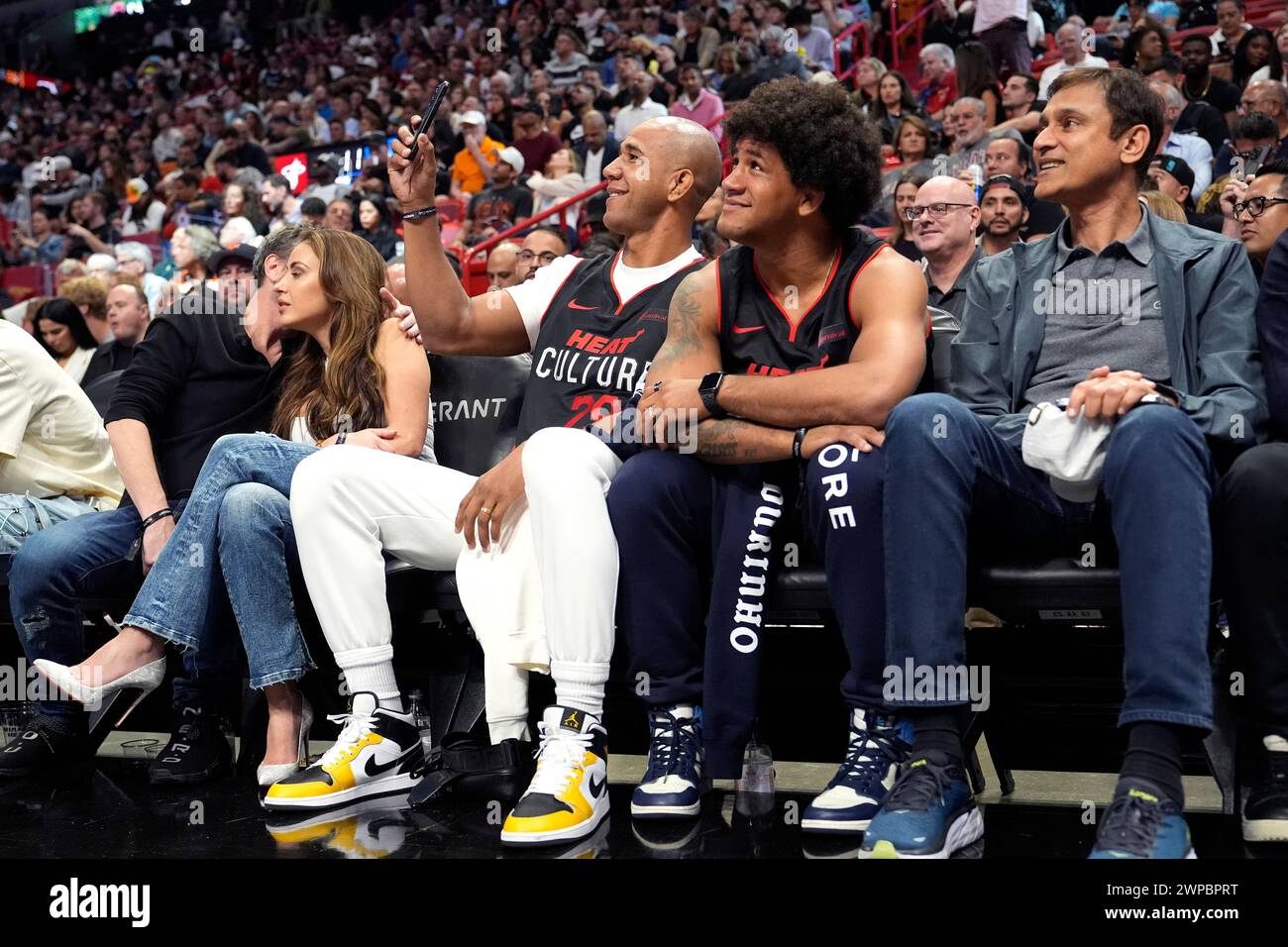 Mixed martial artist Gilbert Burns of Brazil, second from right, sits ...