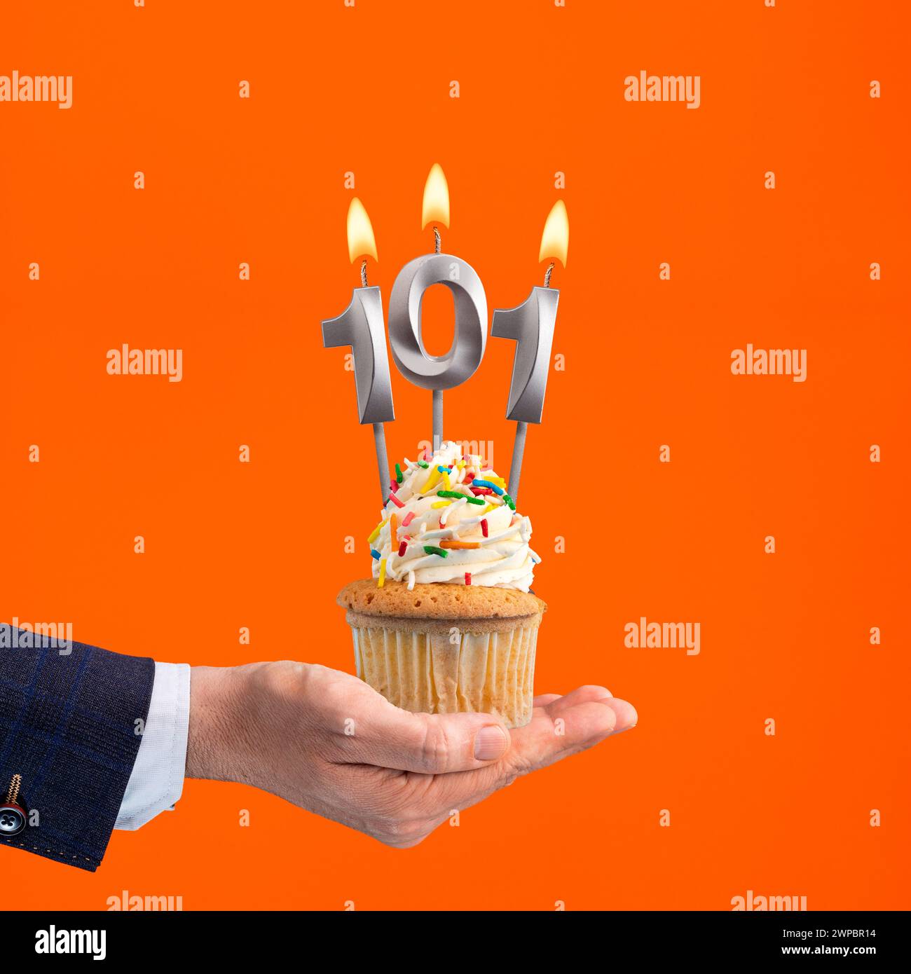 Hand holding birthday cupcake with number 101 candle - background ...