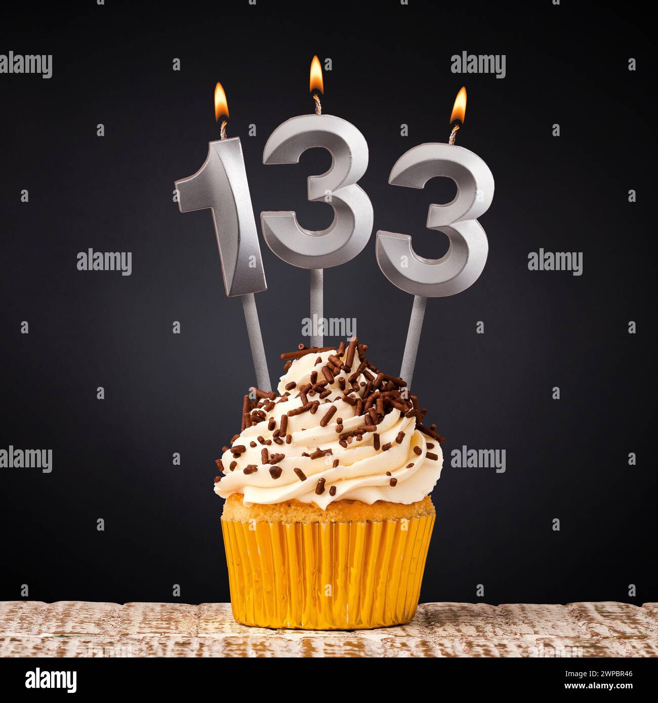 Birthday candle number 133 - Anniversary cupcake on black background ...