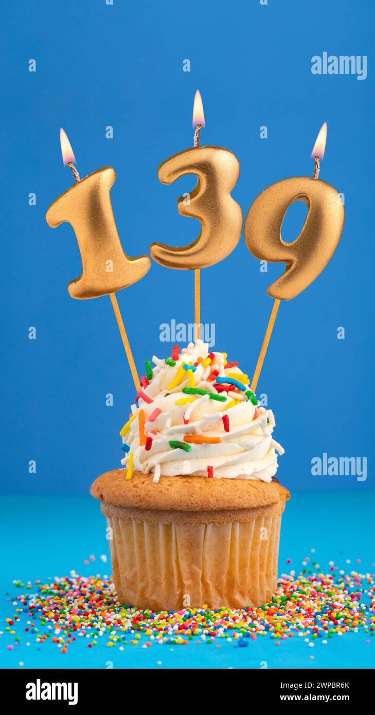 Candle number 139 - Cupcake birthday in blue background Stock Photo - Alamy
