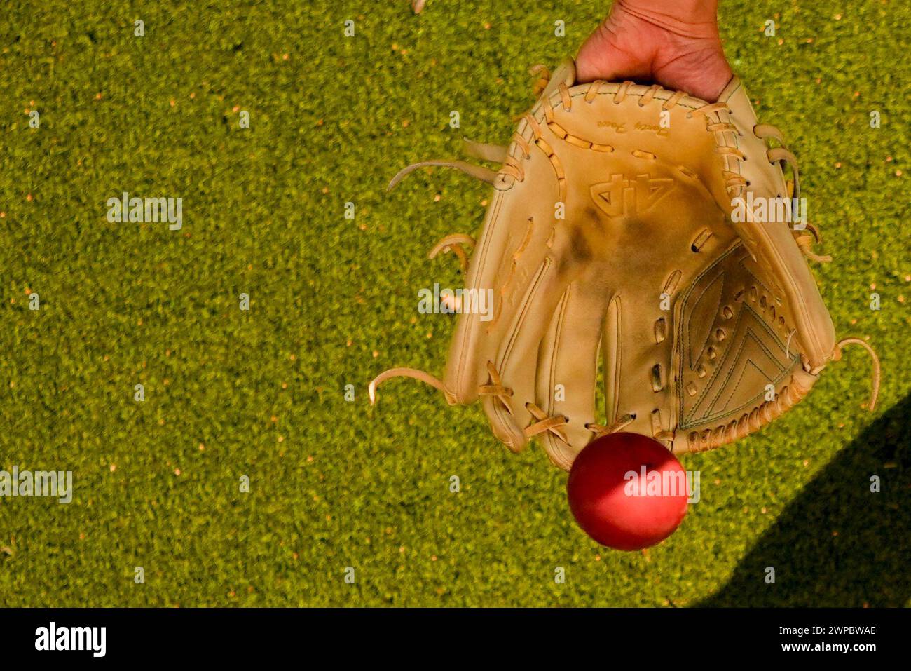 A Kansas City Royals pitcher warms up with a rubber ball in the bullpen ...