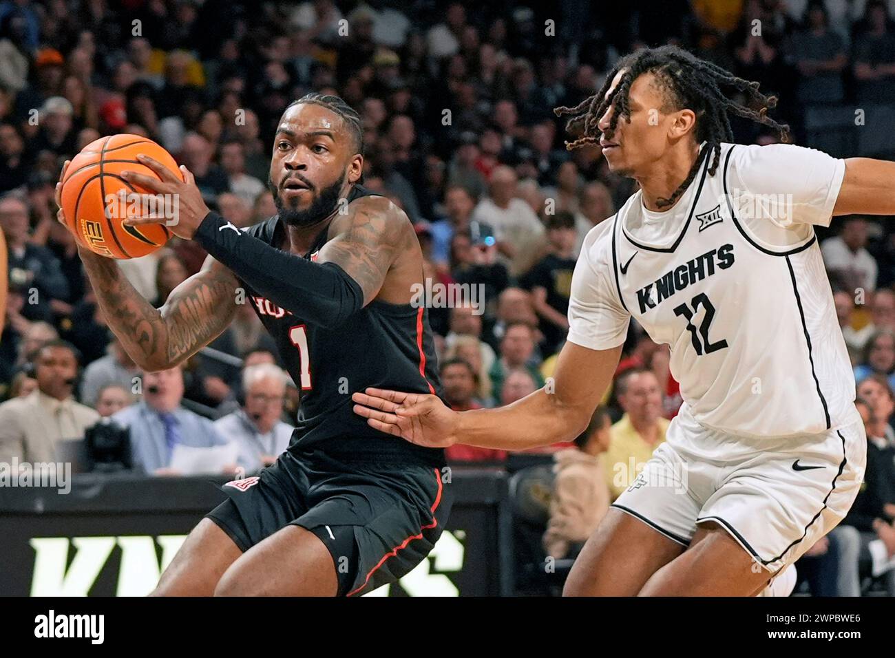 Houston guard Jamal Shead (1) drives past Central Florida guard DeMarr ...