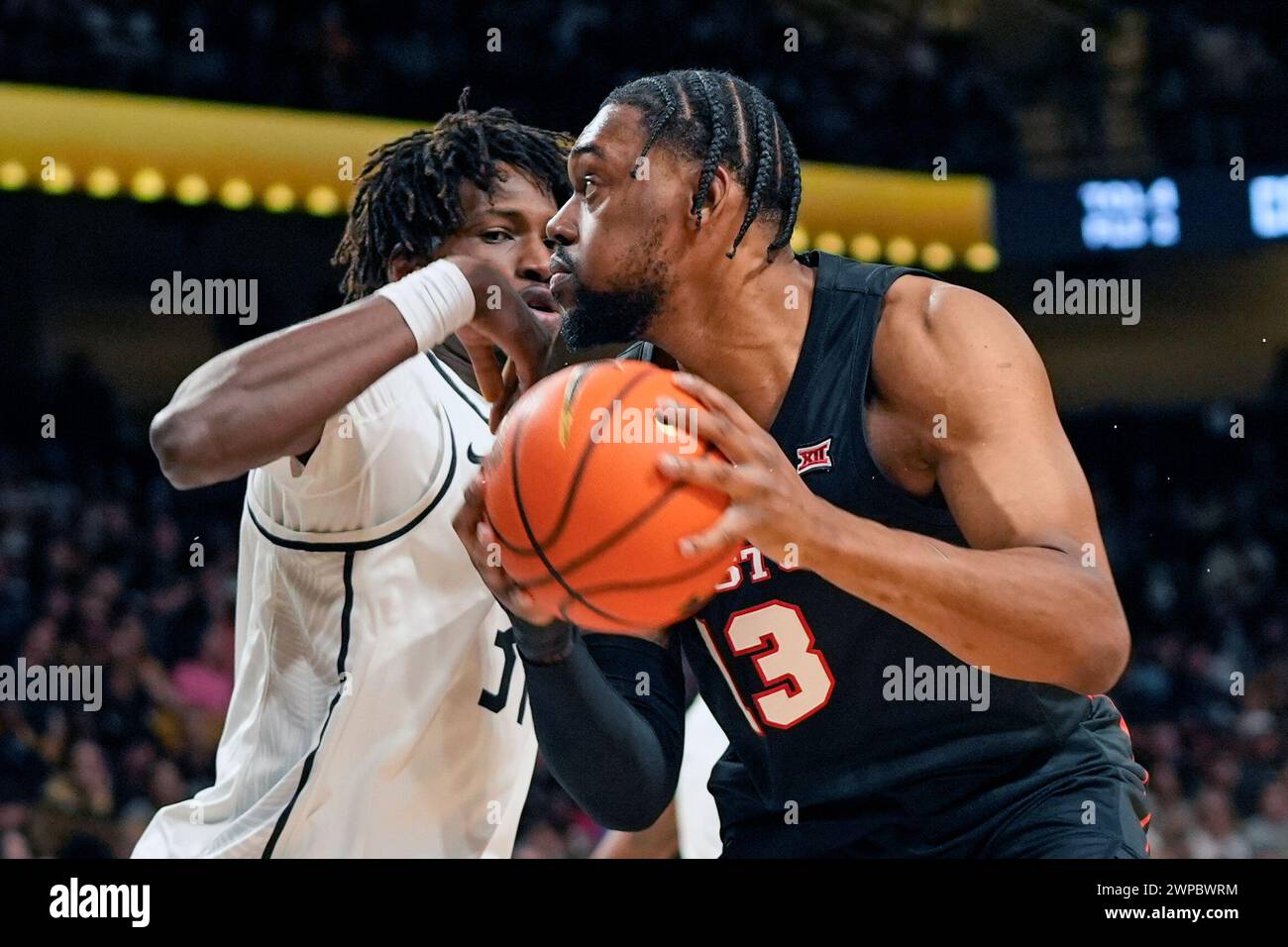 Houston forward J'Wan Roberts, right, looks for a path to the basket ...