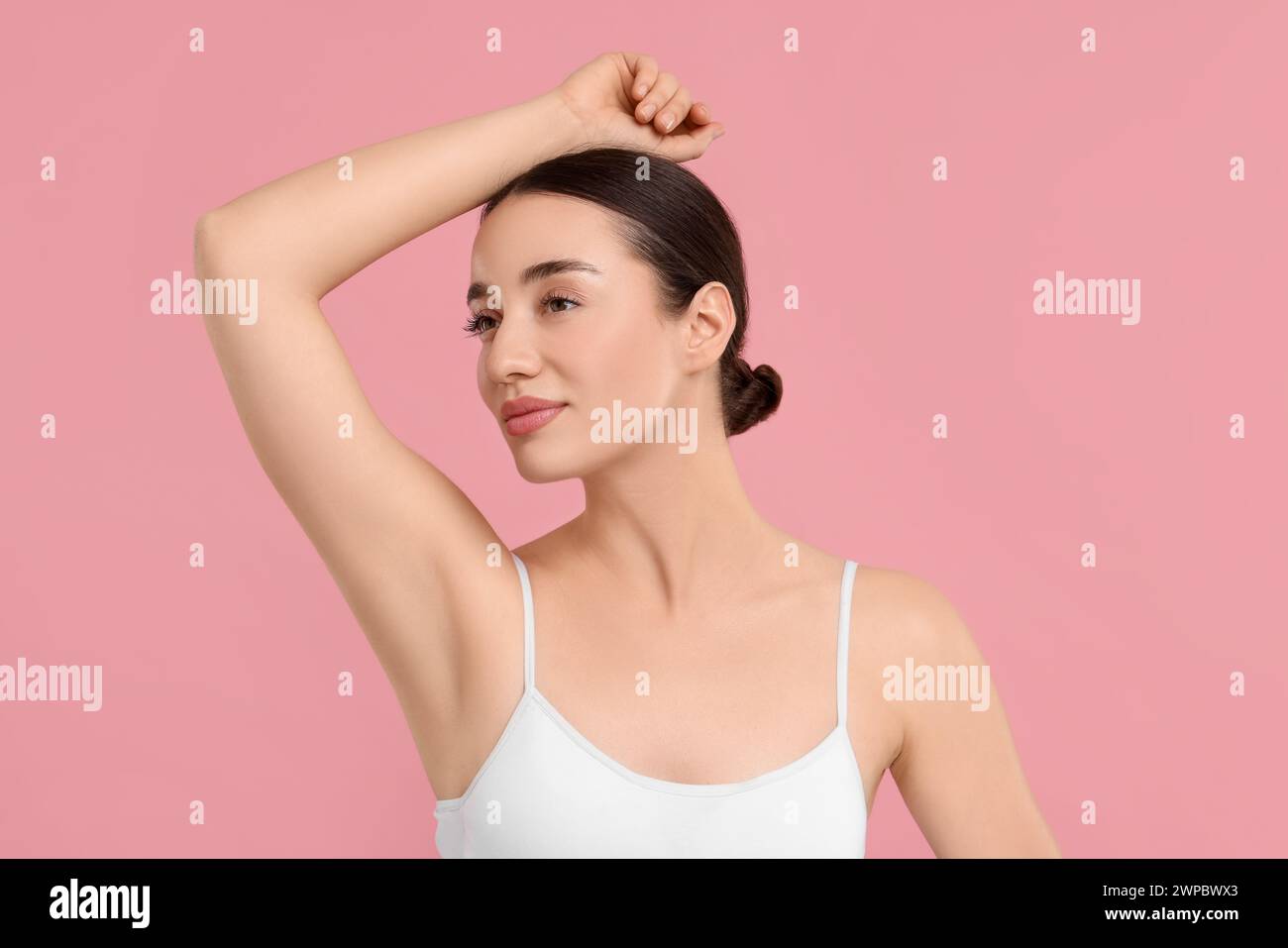 Beautiful woman showing armpit with smooth clean skin on pink ...