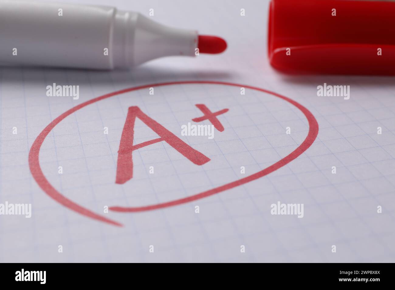 School grade. Red letter A with plus symbol on notebook paper and ...
