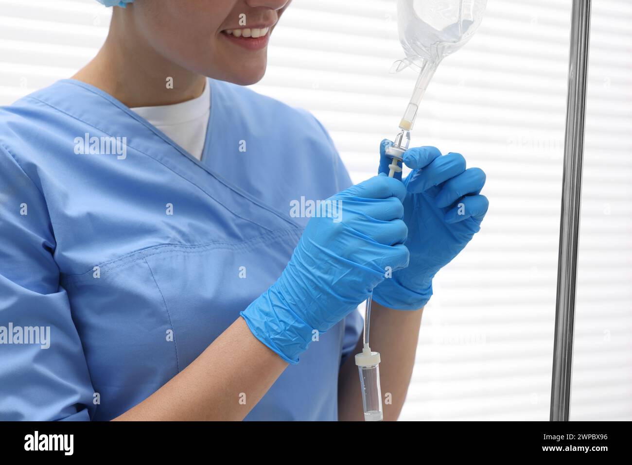 Nurse setting up IV drip in hospital, closeup Stock Photo - Alamy
