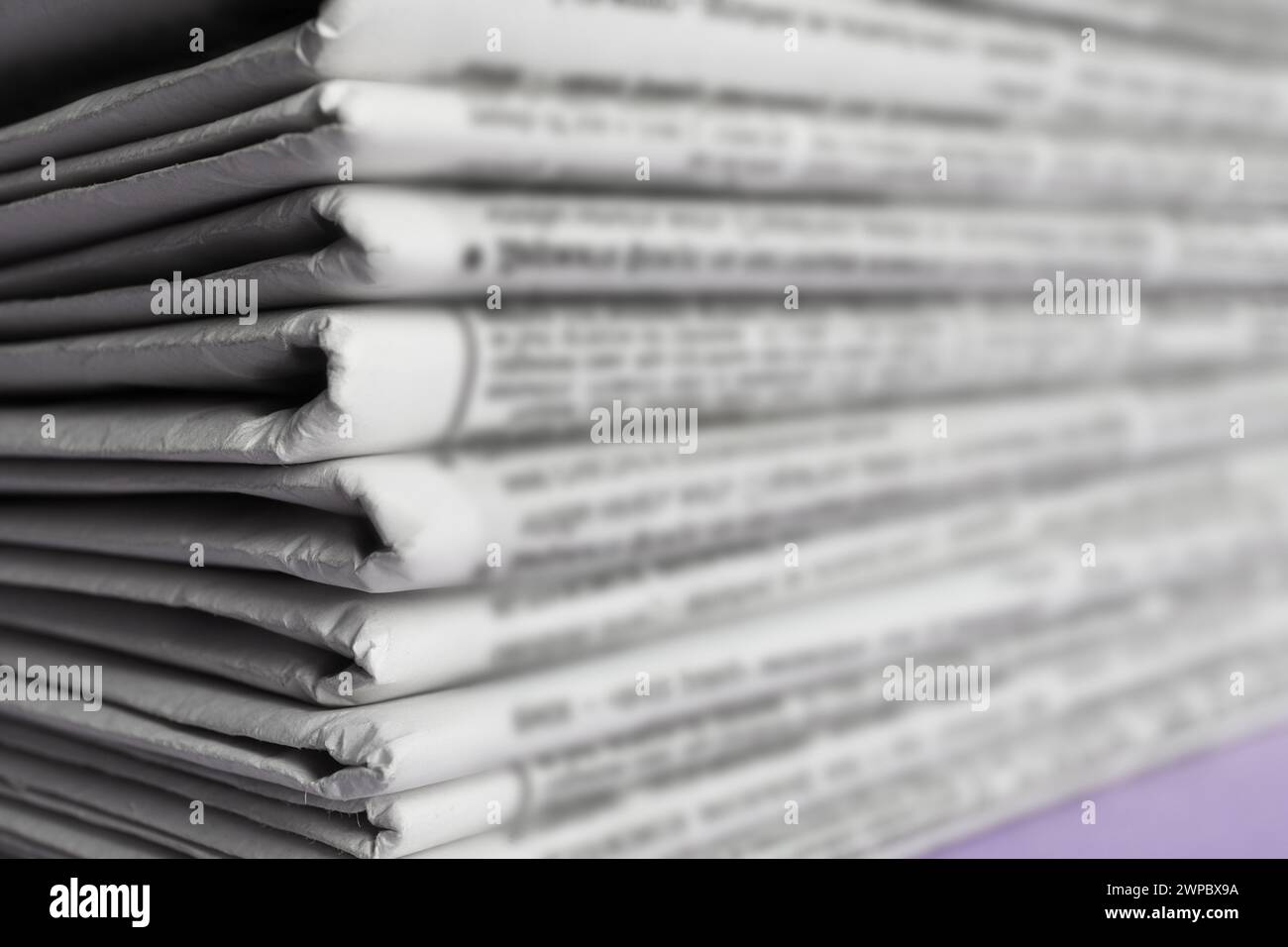 Stack of newspapers on light violet background, closeup. Journalist's ...