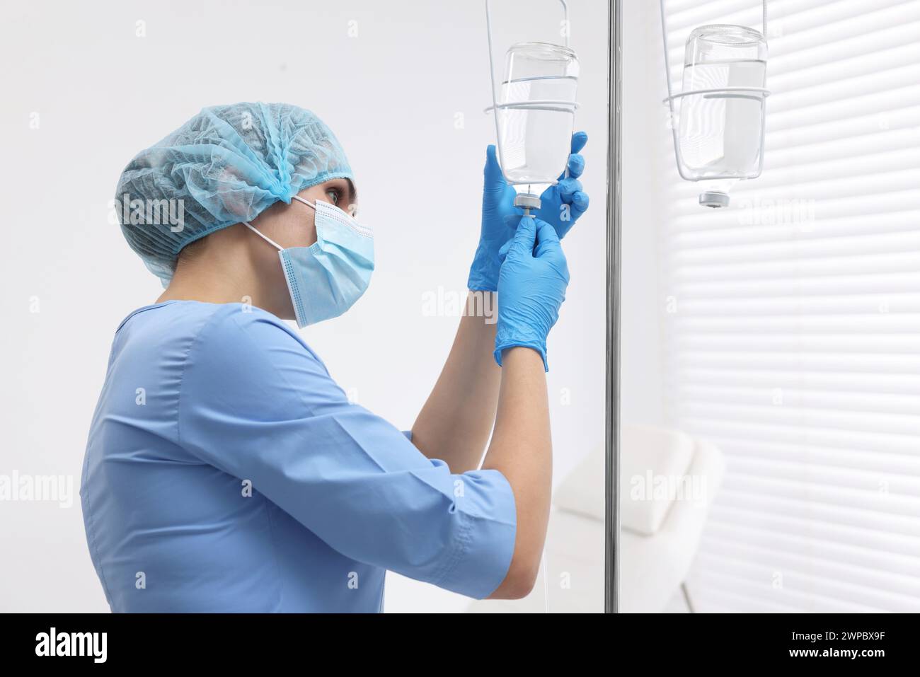 Nurse setting up IV drip in hospital Stock Photo - Alamy
