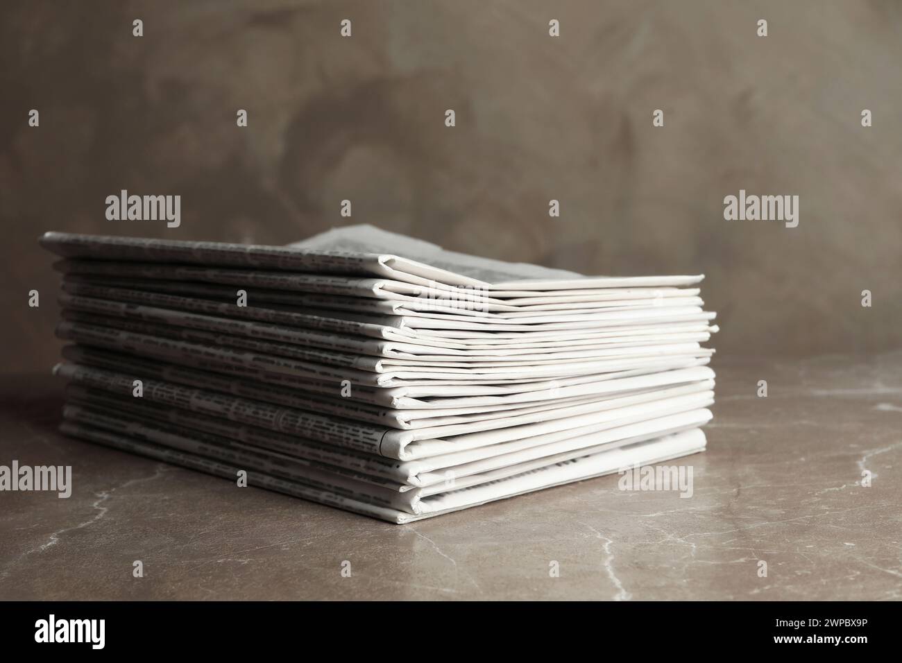 Stack of newspapers on marble table. Journalist's work Stock Photo - Alamy
