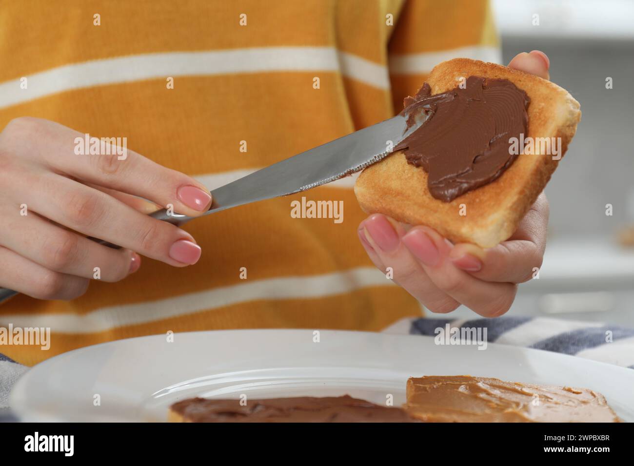 Woman spreading chocolate onto hi-res stock photography and images - Alamy