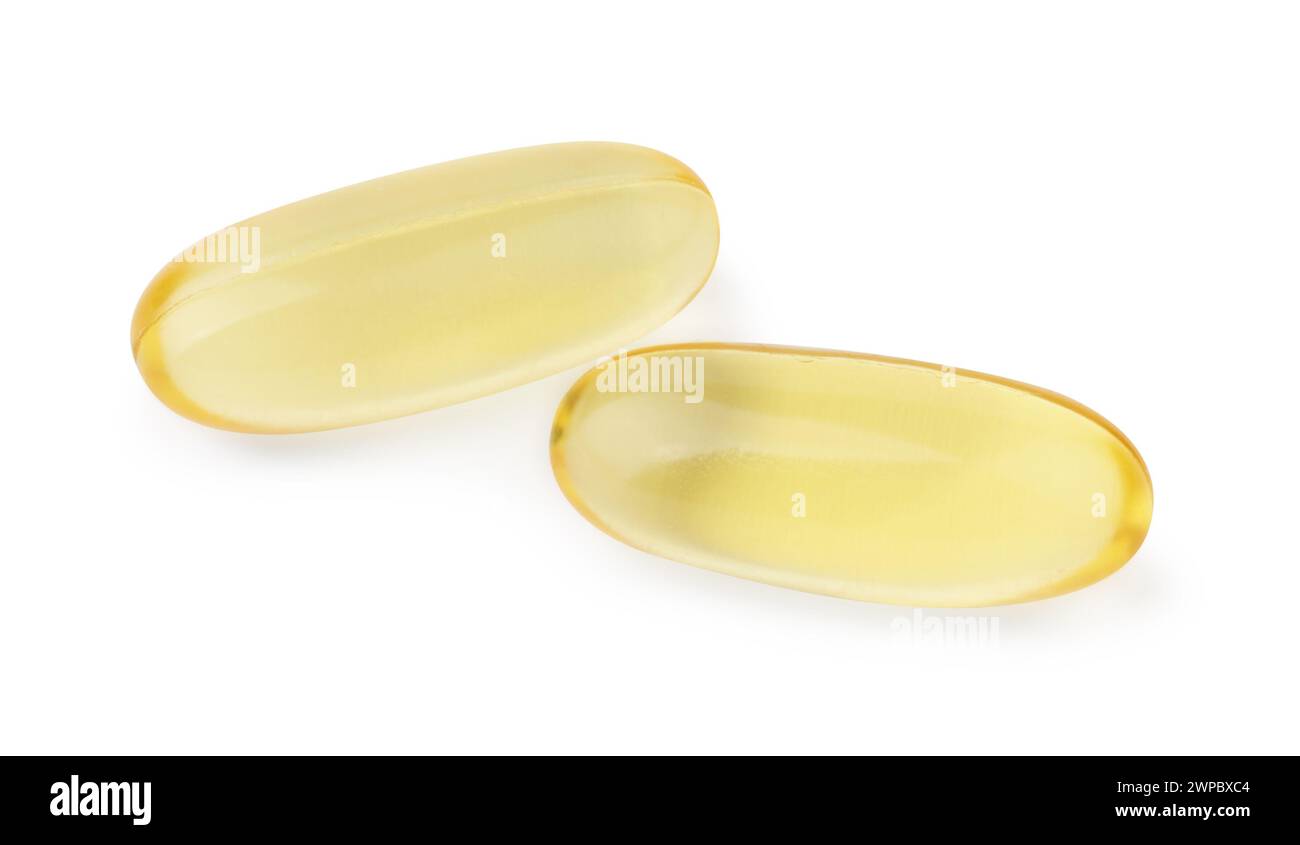 Yellow vitamin capsules isolated on white, top view Stock Photo - Alamy