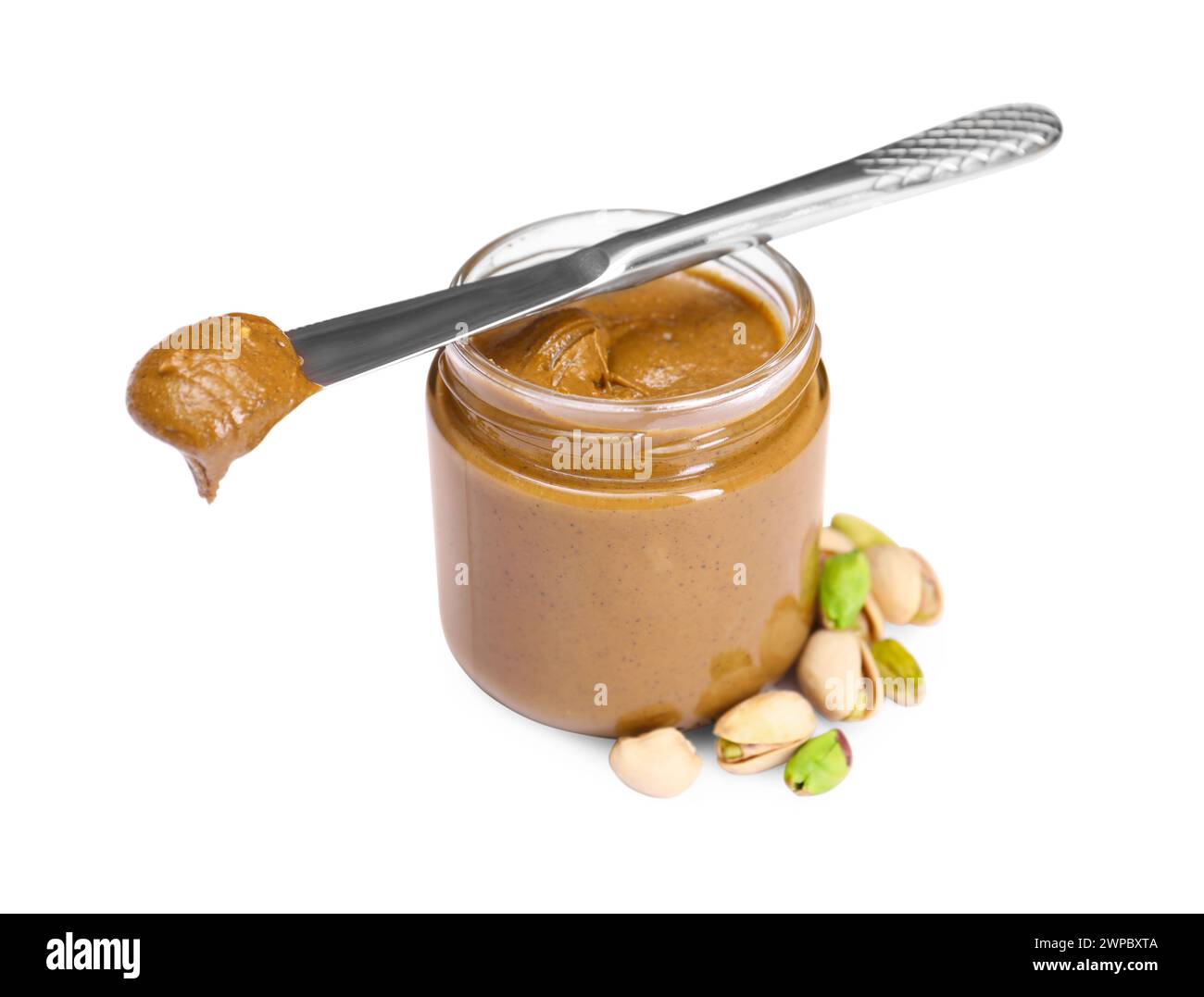 Tasty nut paste in jar, knife and pistachios isolated on white Stock ...