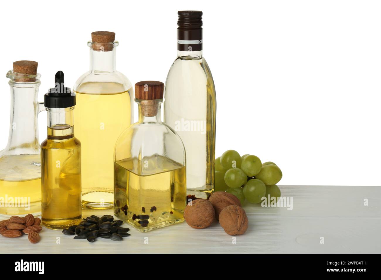 Vegetable fats. Different cooking oils and ingredients on wooden table ...