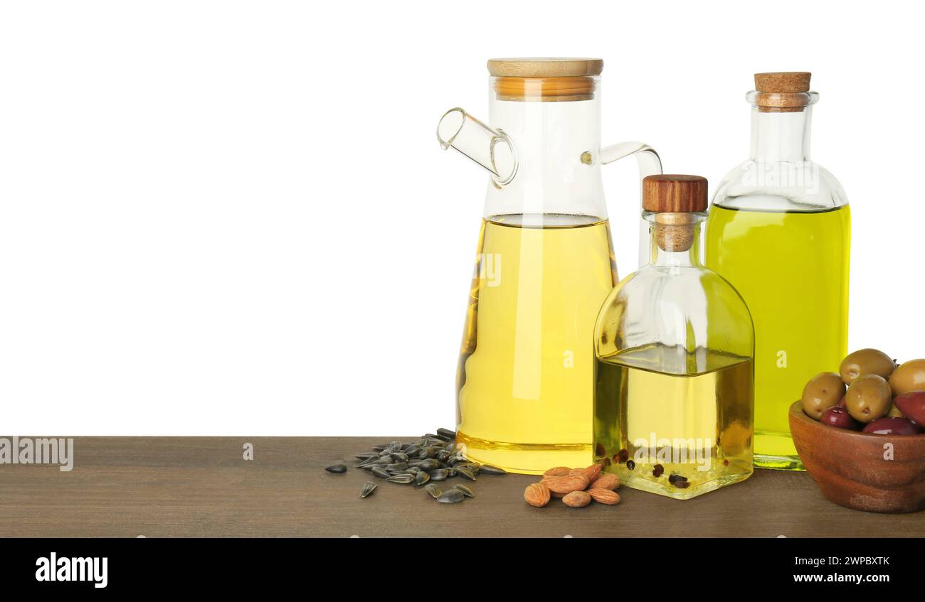 Vegetable fats. Different cooking oils and ingredients on wooden table ...