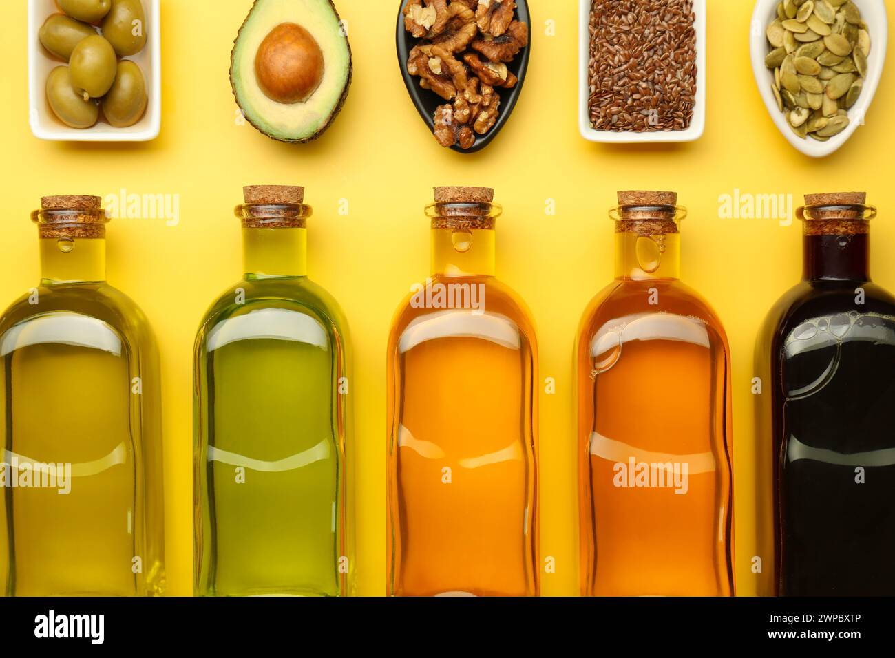 Vegetable fats. Different oils in glass bottles and ingredients on ...