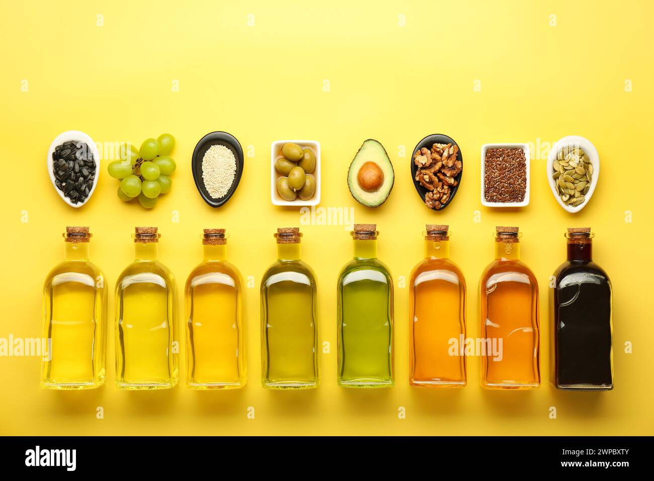 Vegetable fats. Different oils in glass bottles and ingredients on ...