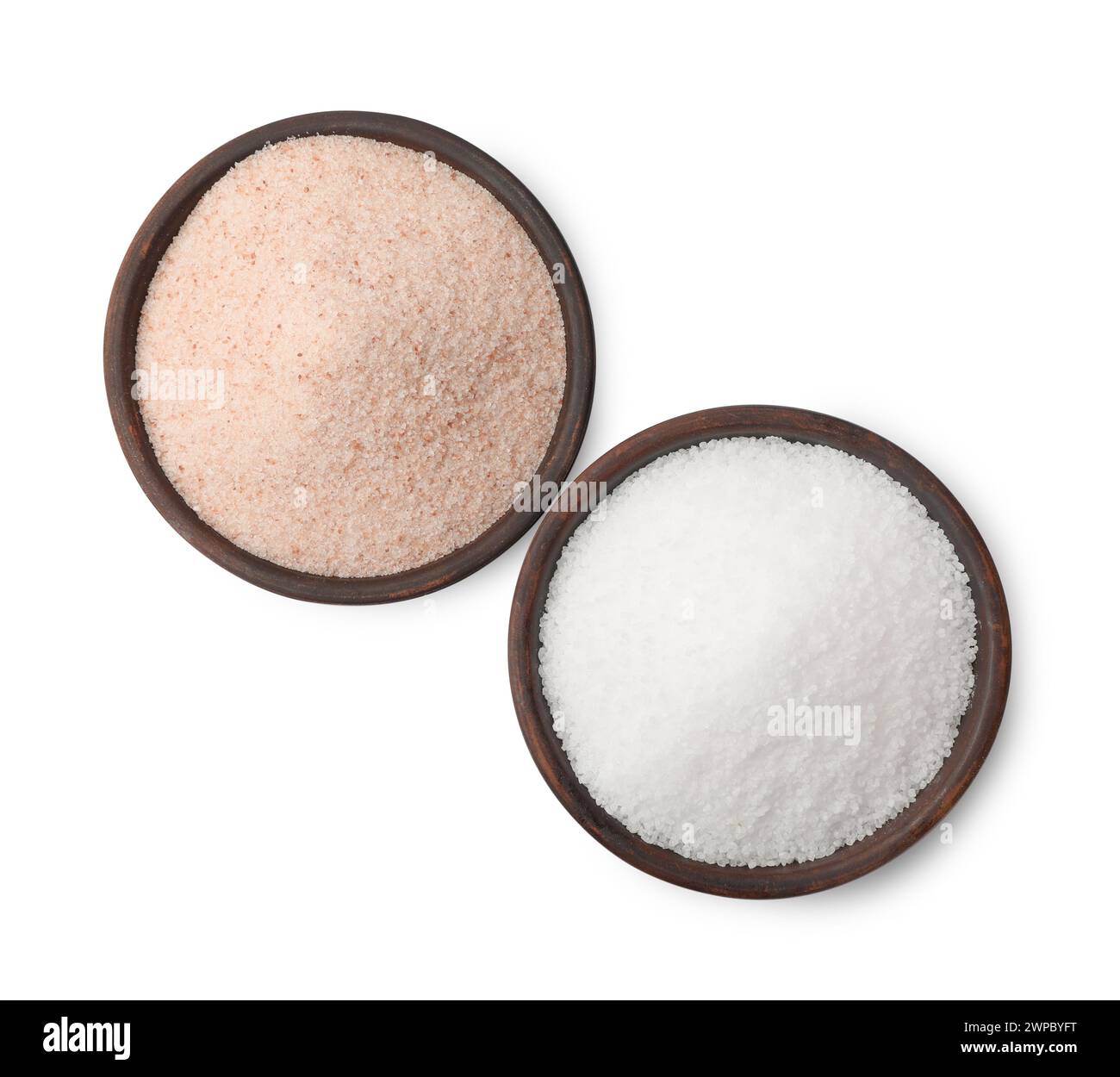 Different types of natural salt in bowls isolated on white, top view ...