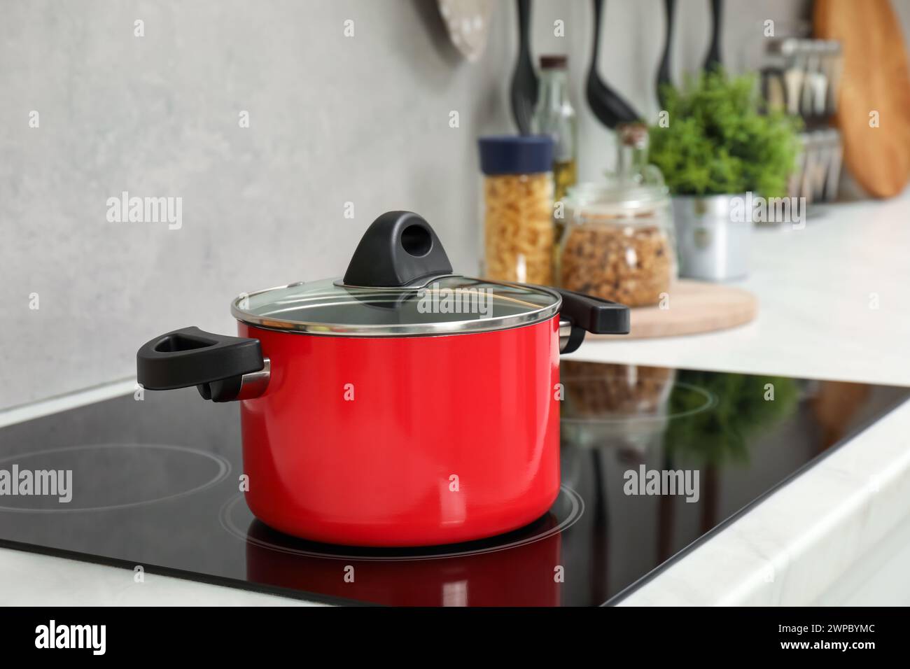 Cooking dinner. Pot on cooktop in kitchen Stock Photo - Alamy