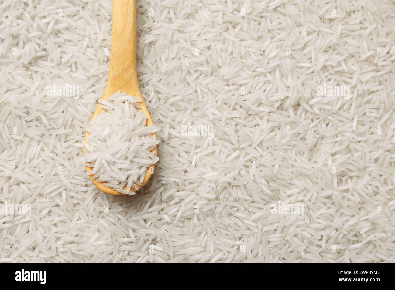 Raw basmati rice and spoon, top view. Space for text Stock Photo - Alamy
