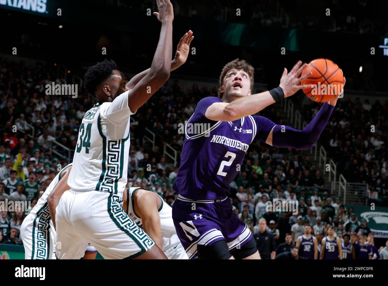 Northwestern forward Nick Martinelli (2), right, looks to shoot against ...