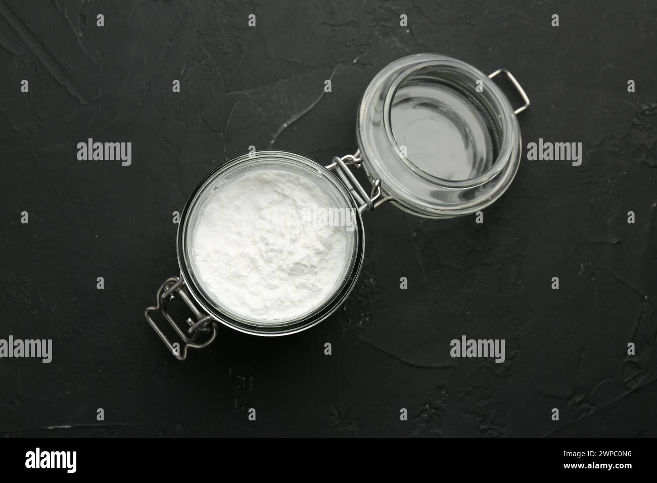 Baking powder in jar on black textured table, top view Stock Photo - Alamy