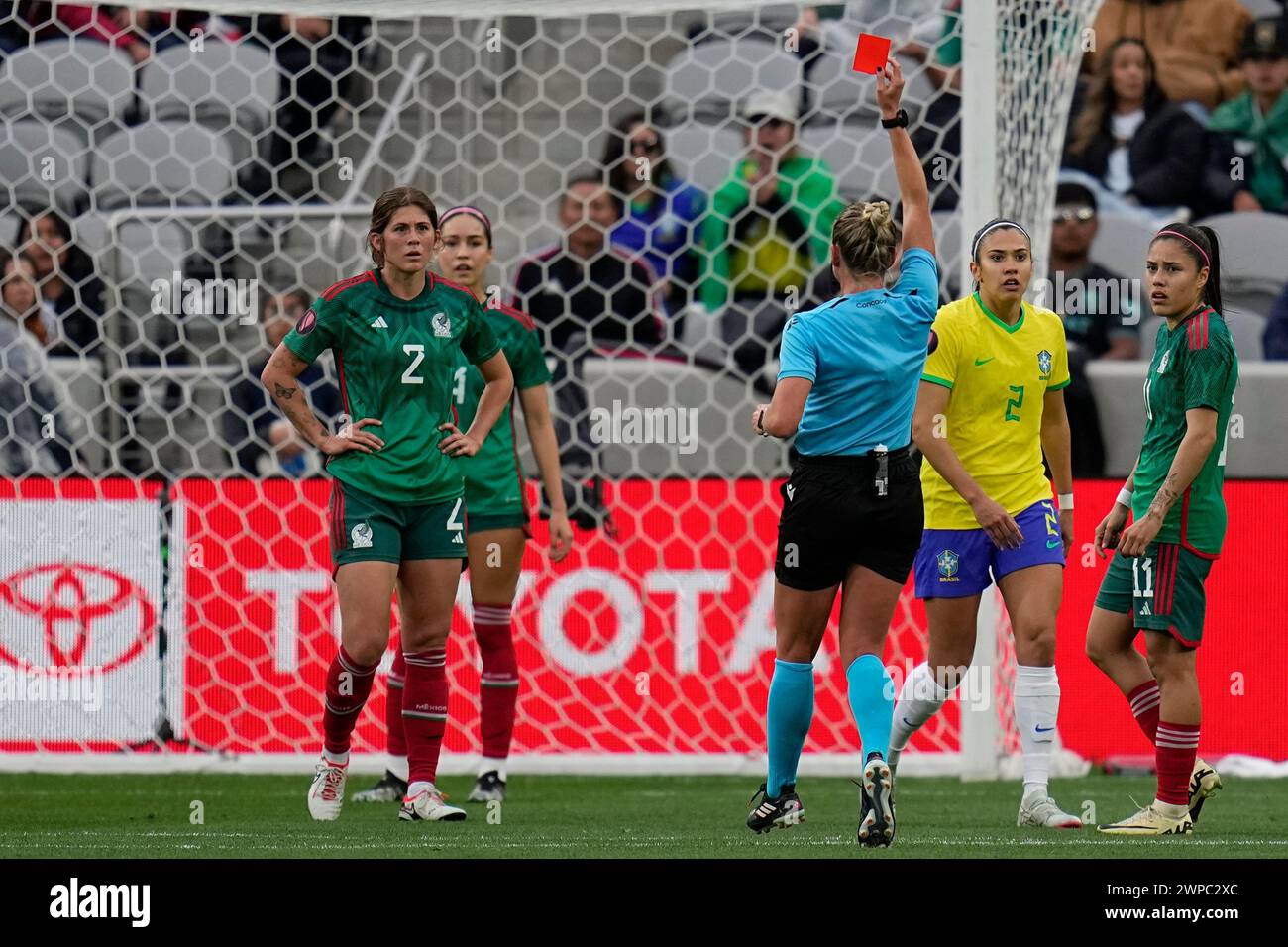 Mexico's Nicolette Hernandez, right, is shown a red card by referee ...