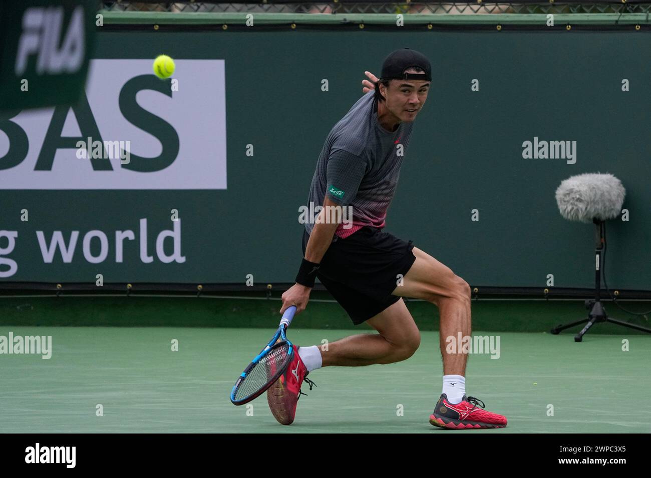 Taro Daniel, of Japan, hits a return to Daniel Elahi Galan, of Colombia ...