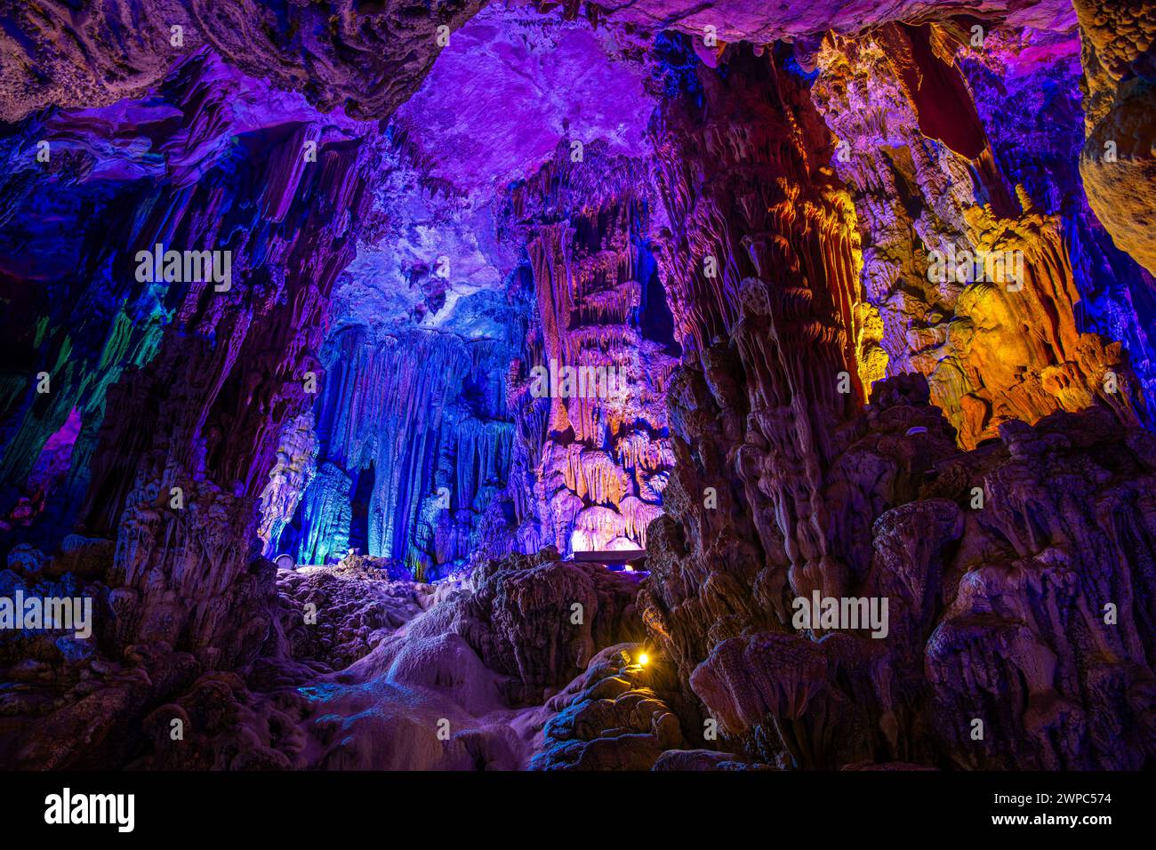 Inside the cave. Stalactites, stalagmites, colored light. Beautiful ...