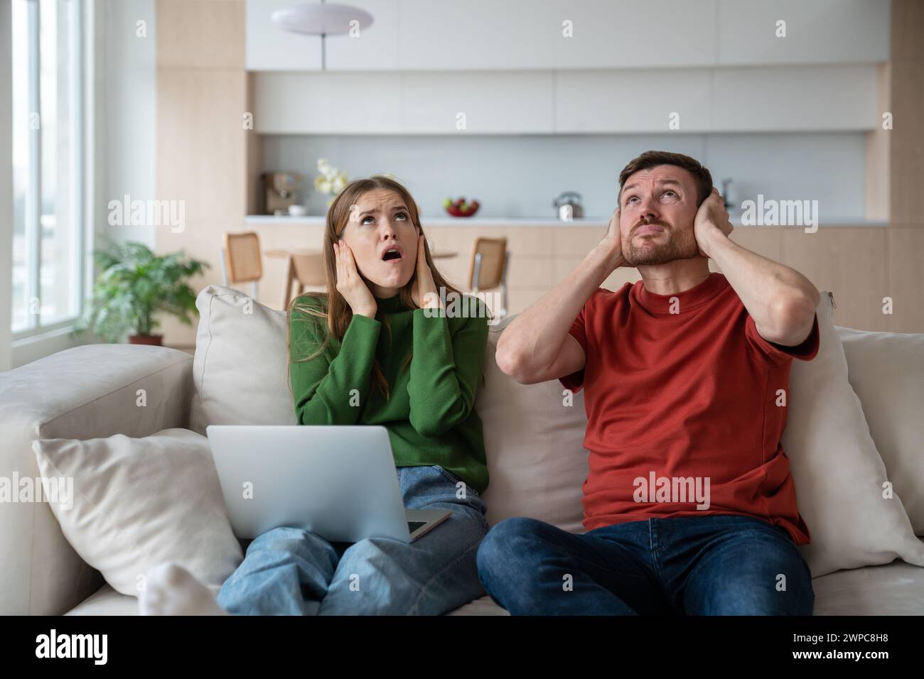 Husband and wife covered ears in anger due to loud noise of housemates ...